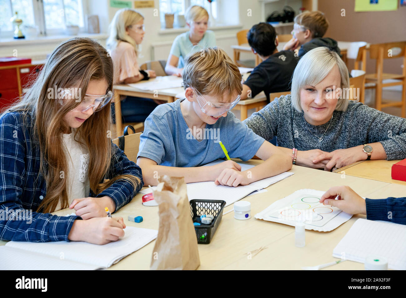 Children with teacher in classroom Stock Photo - Alamy