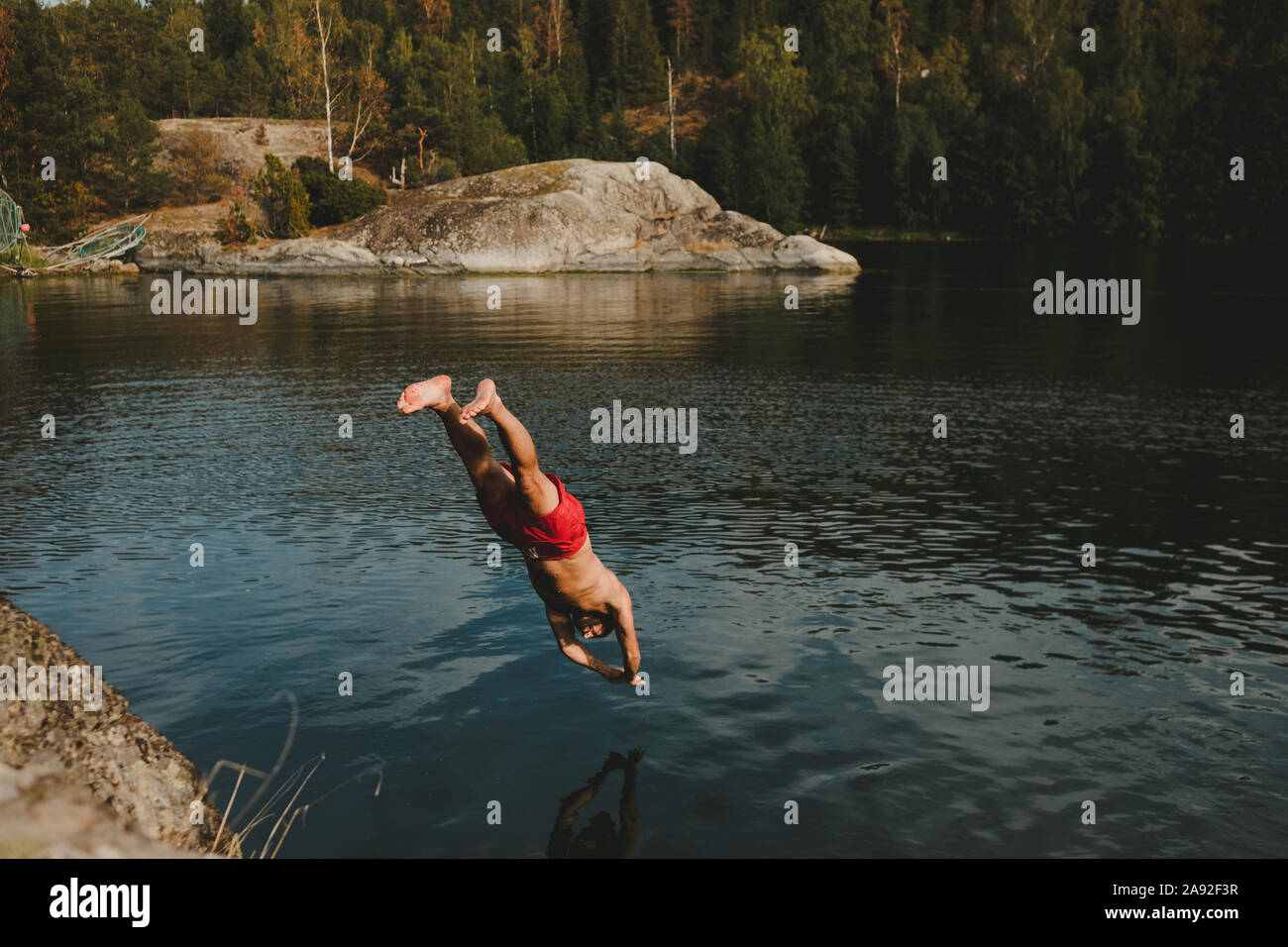 Man jumping into sea Stock Photo - Alamy