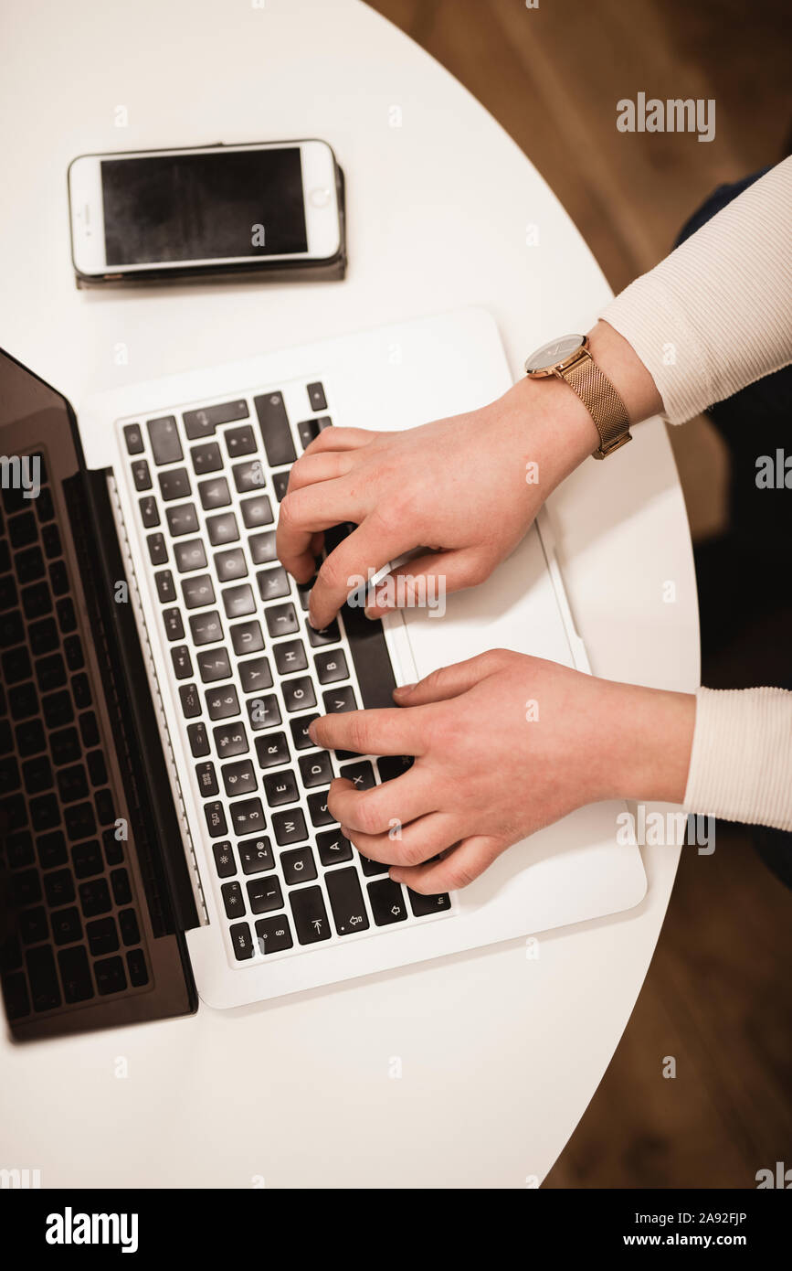 Hands typing on laptop keyboard Stock Photo - Alamy