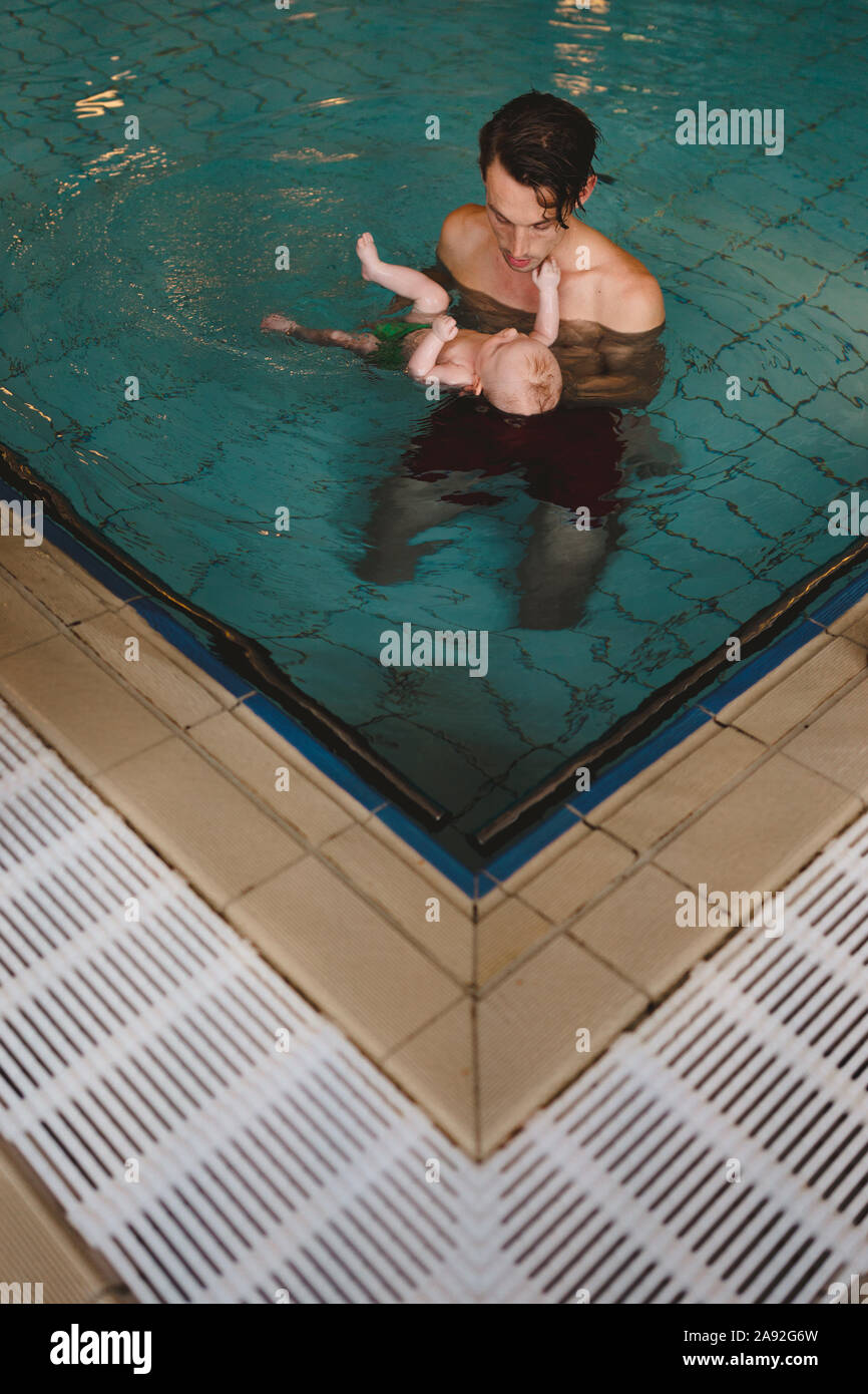 Father with baby in swimming-pool Stock Photo - Alamy