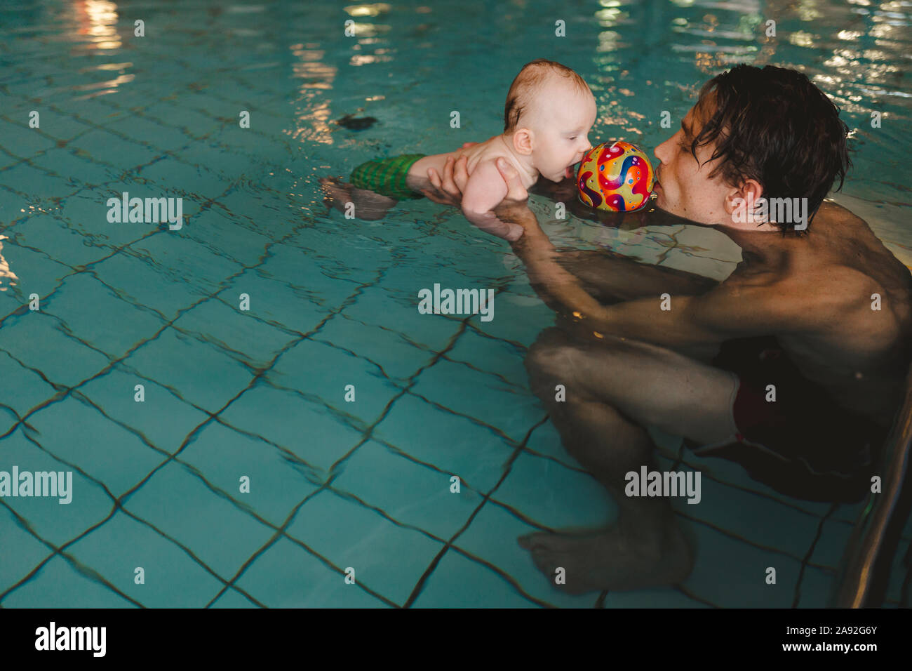 Father with baby in swimming-pool Stock Photo - Alamy