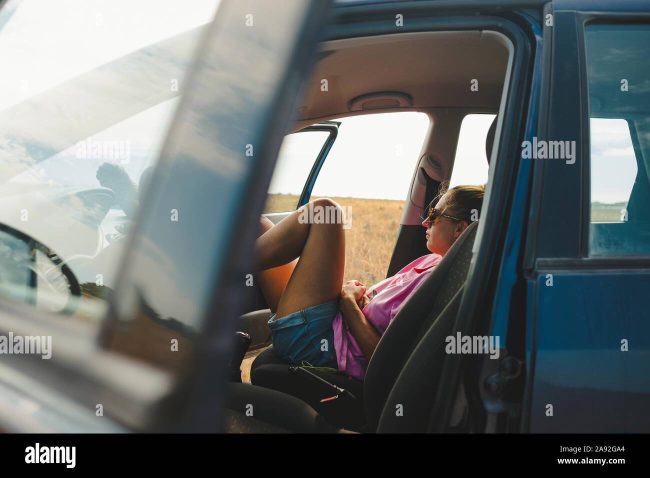 Woman relaxing in car Stock Photo - Alamy