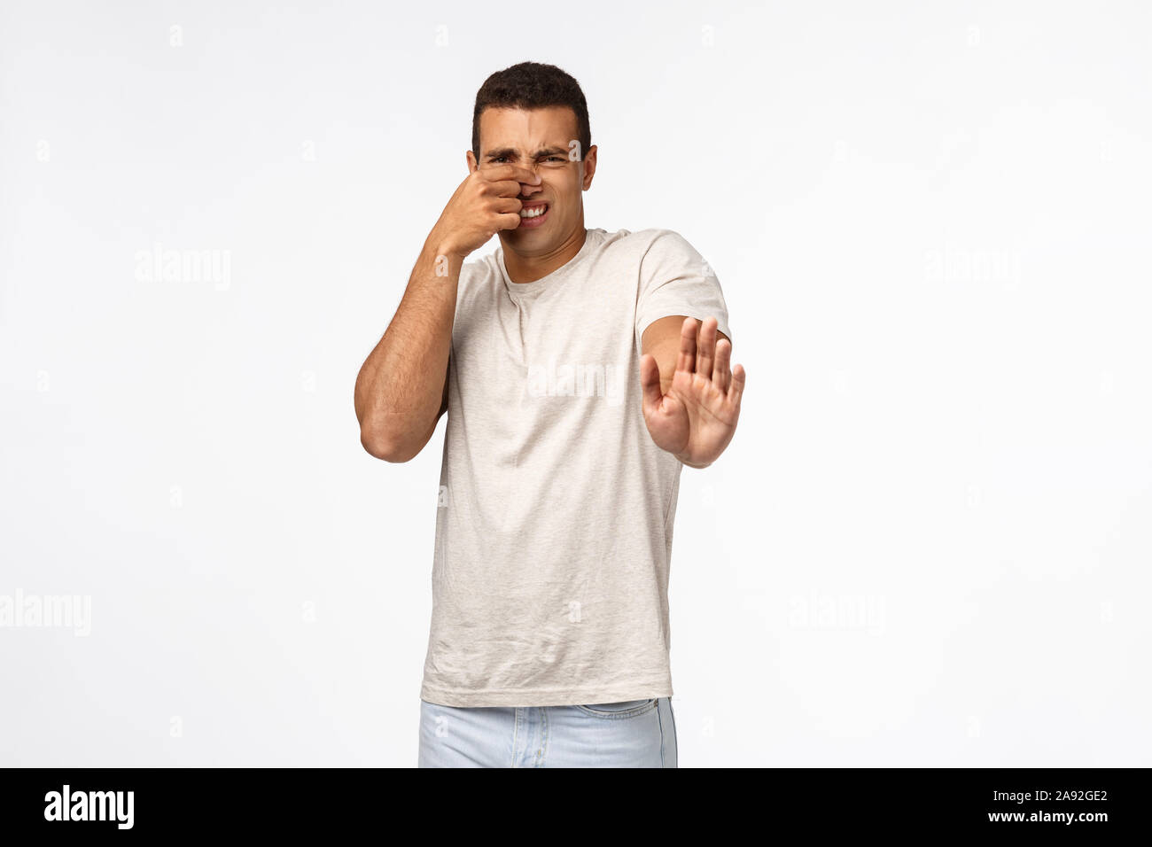 Guy feel disgusted from awful bad smell, rejecting stinky cheese plate ...