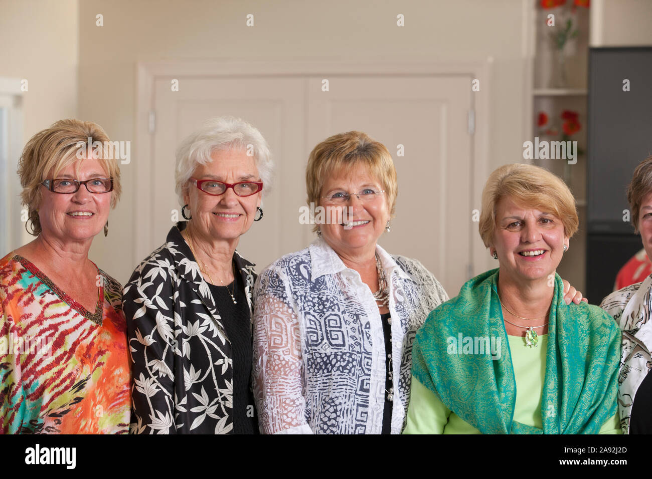 Portrait of four senior female friends smiling together Stock Photo - Alamy
