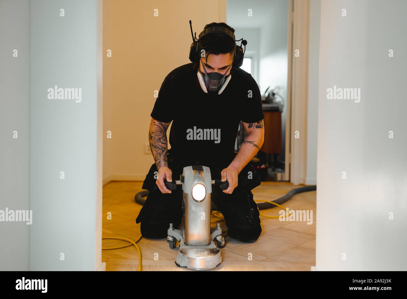 Man sanding floor Stock Photo - Alamy