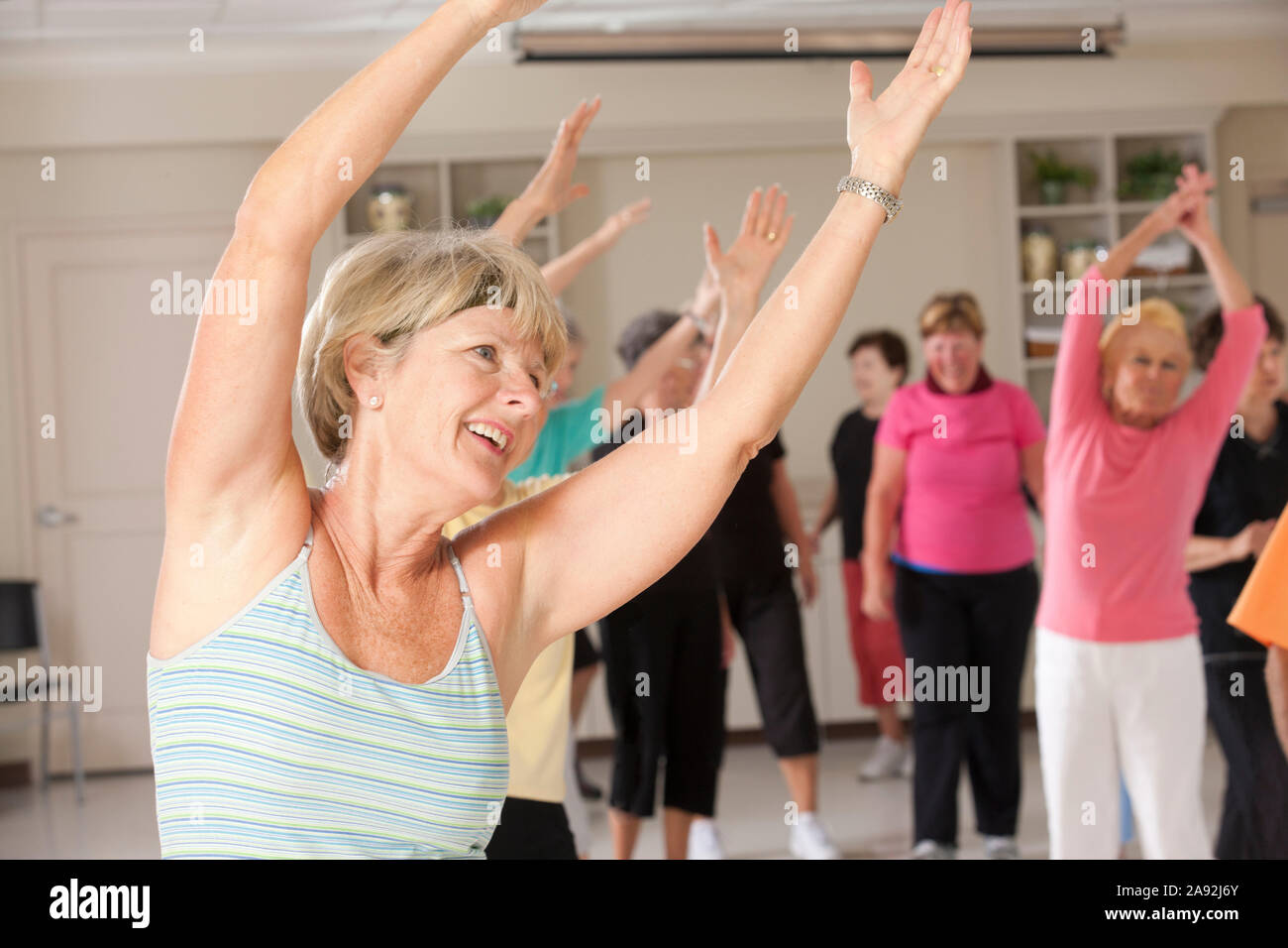 Senior exercise class doing stretching exercise Stock Photo - Alamy