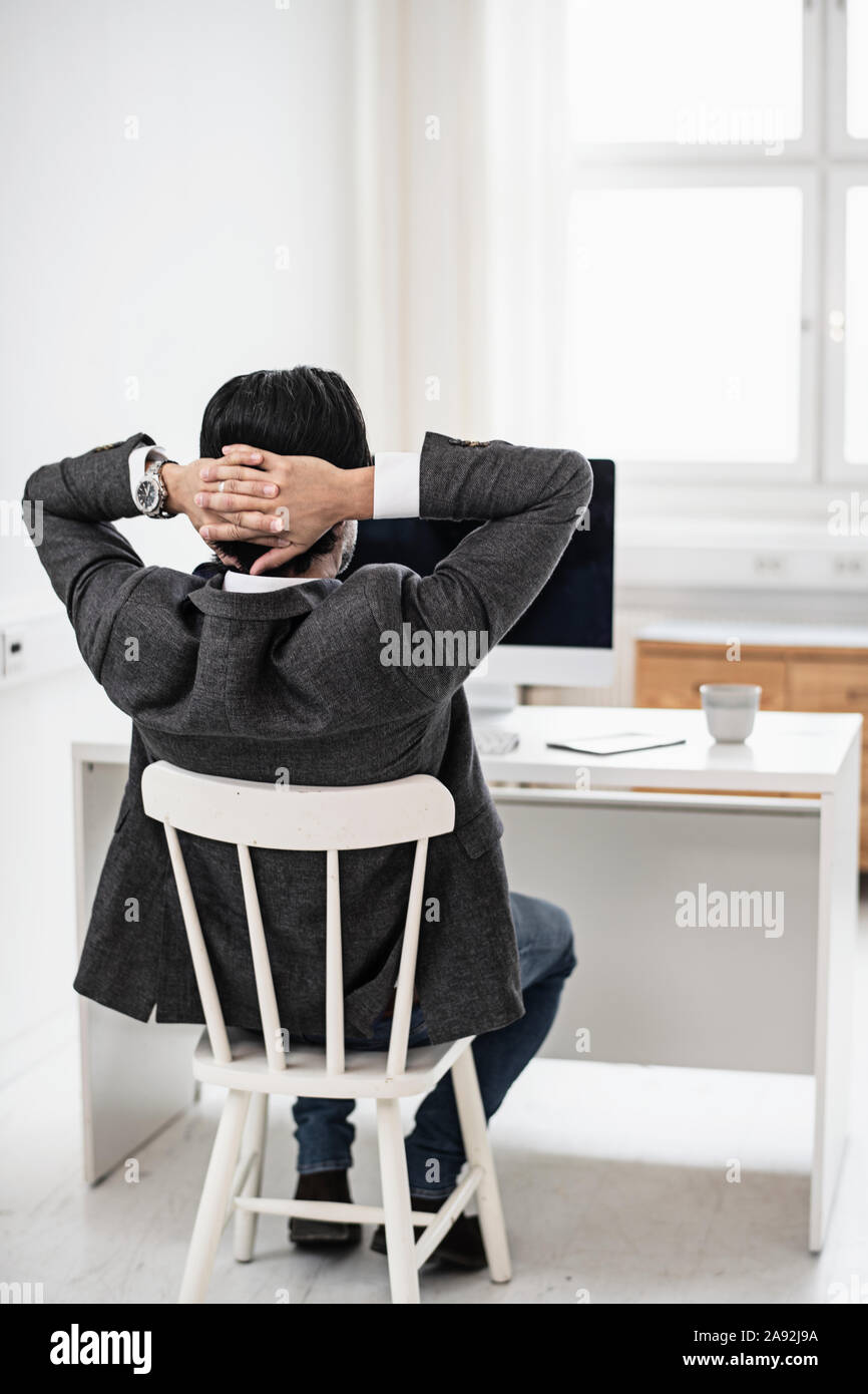 Man sitting desk full view hi-res stock photography and images - Alamy