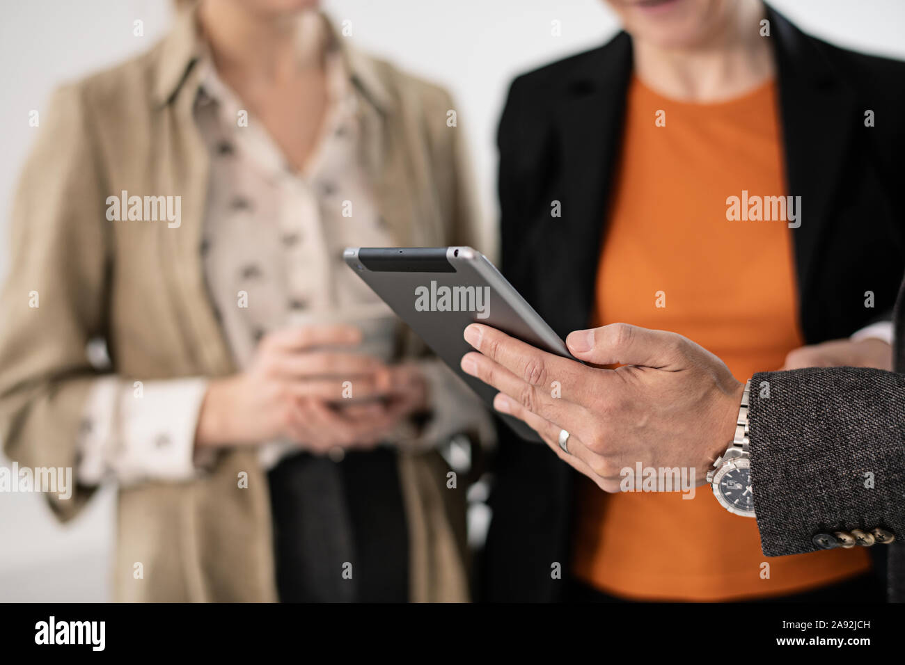 Businessmans hand holding digital tablet Stock Photo - Alamy