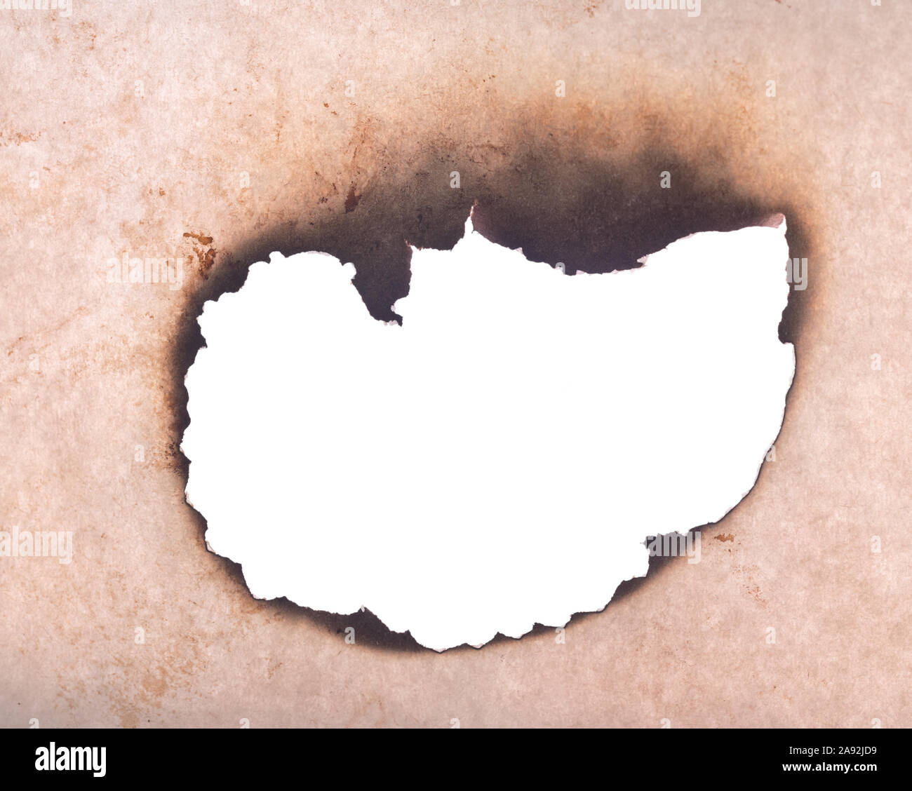 Burnt hole in a paper Stock Photo - Alamy