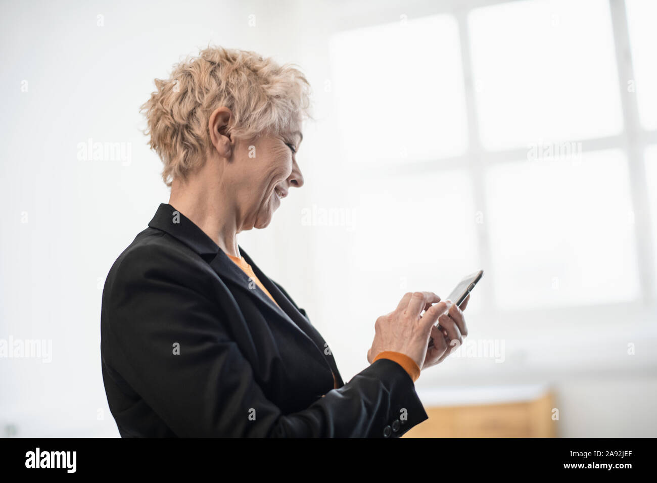 Businesswoman using phone Stock Photo - Alamy