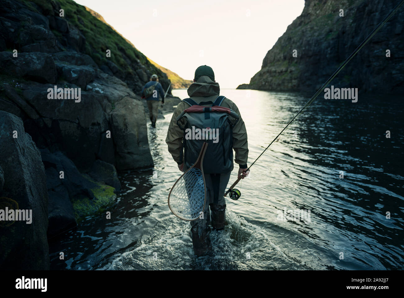 Man walking through river Stock Photo - Alamy