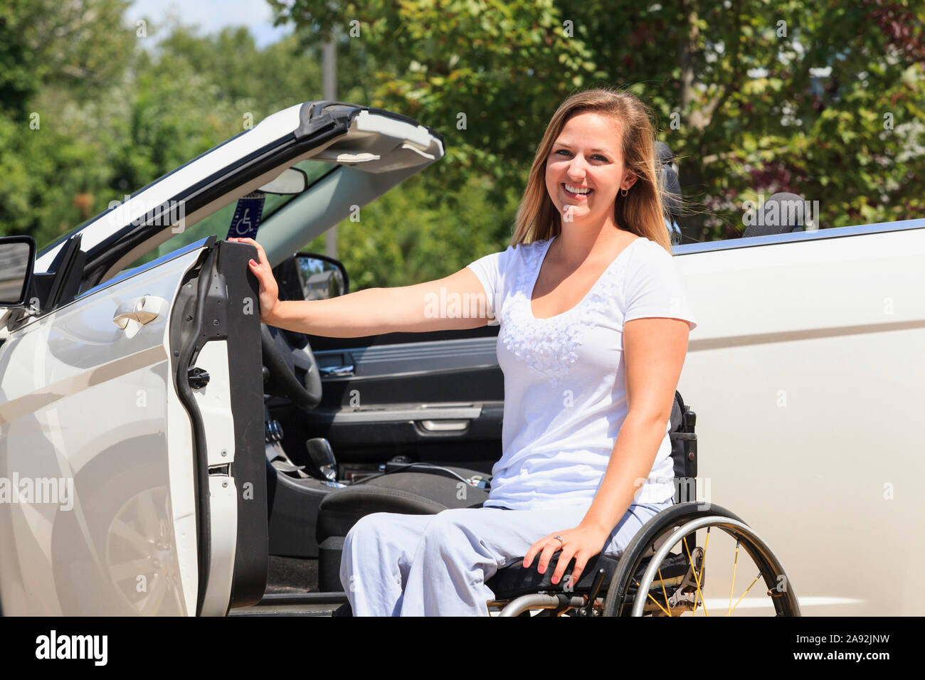 Woman with a spinal cord injury in her wheelchair and getting into her ...
