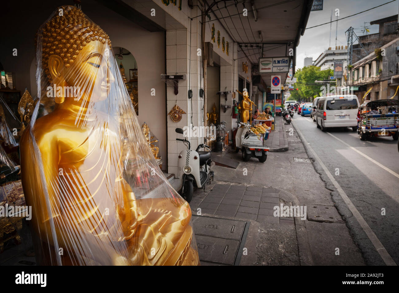 shrink wrapped Buddha statue on the street Stock Photo - Alamy