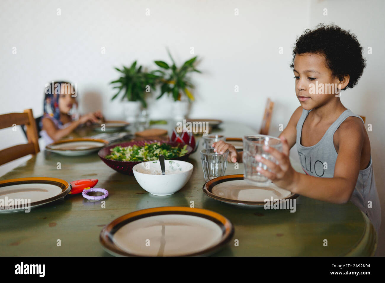 Boy at table Stock Photo - Alamy