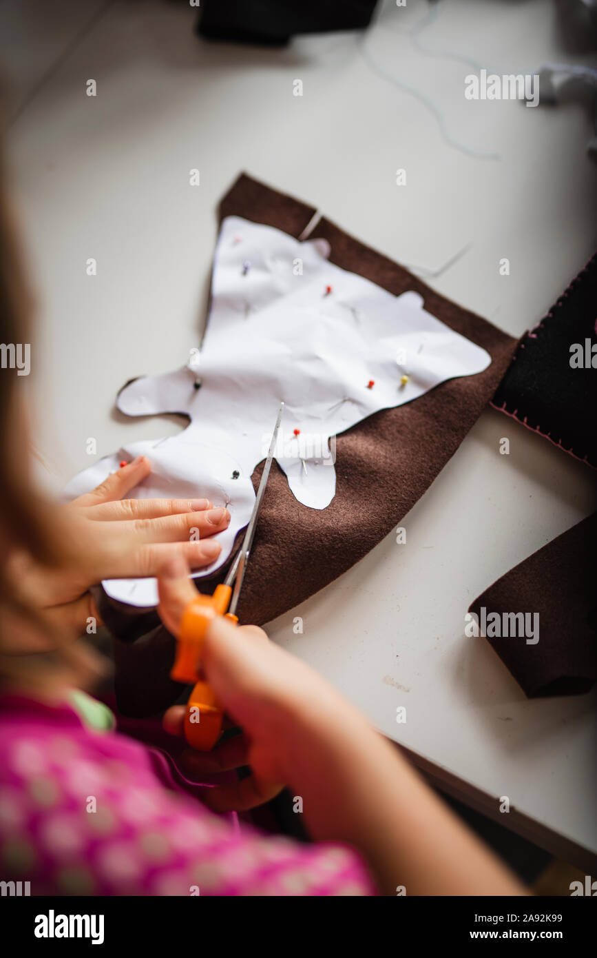 Girl cutting material Stock Photo - Alamy