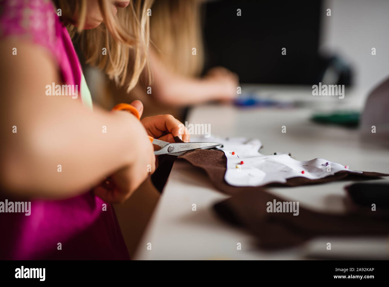 Girl cutting material Stock Photo - Alamy