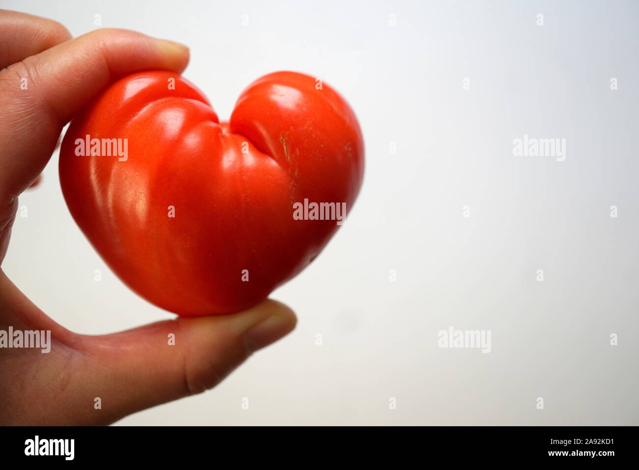 Healthy heart concept (heart health), heart shaped (ox heart) tomato ...