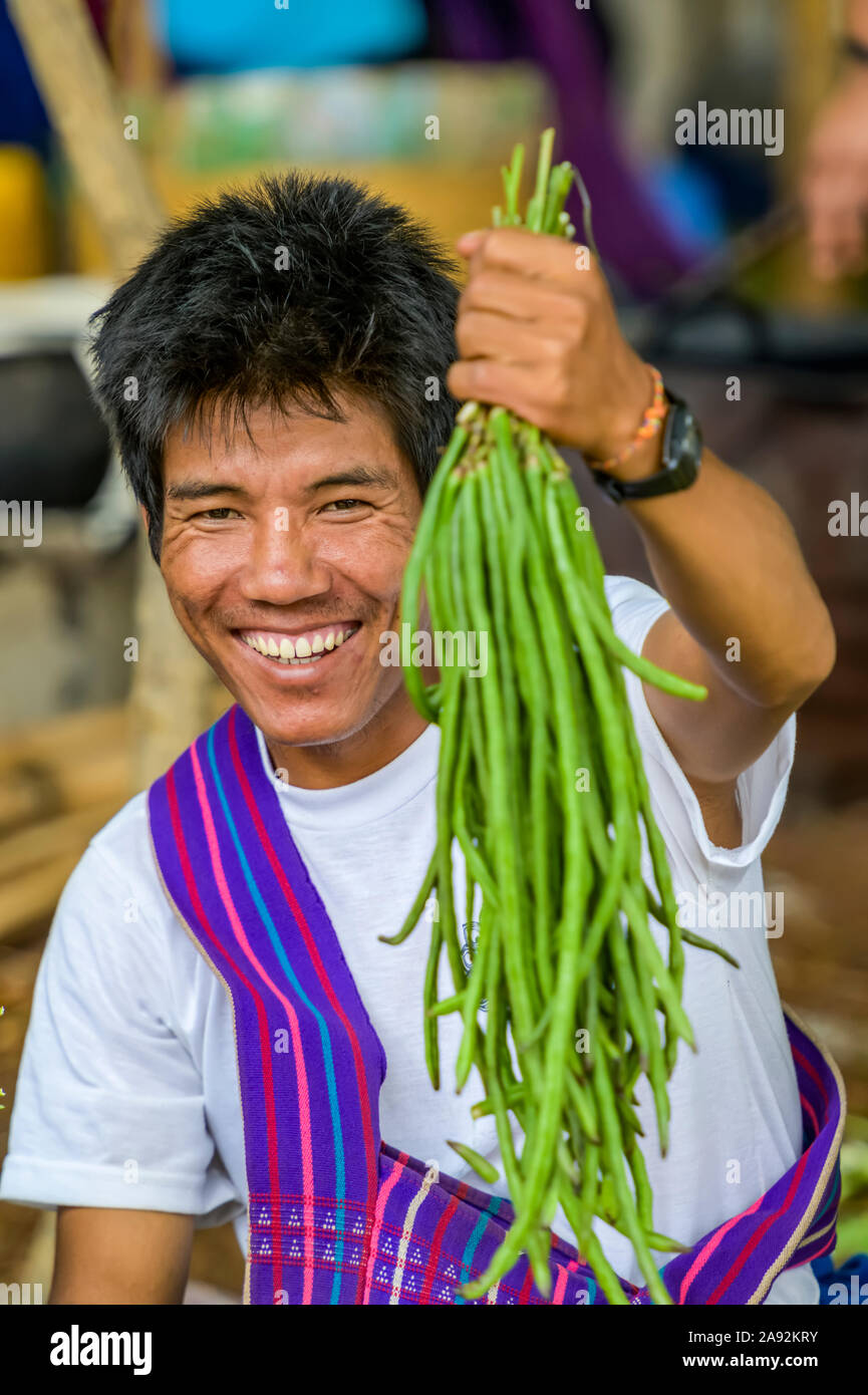 Man holding fresh beans; Shan State, Myanmar Stock Photo - Alamy