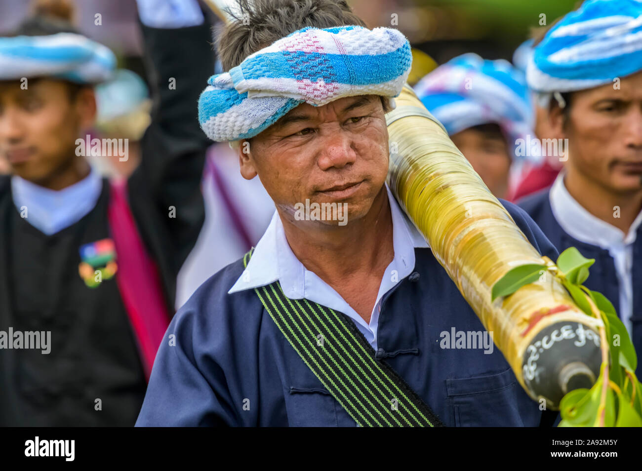 Group of men with a rocket walking together during a festival ...