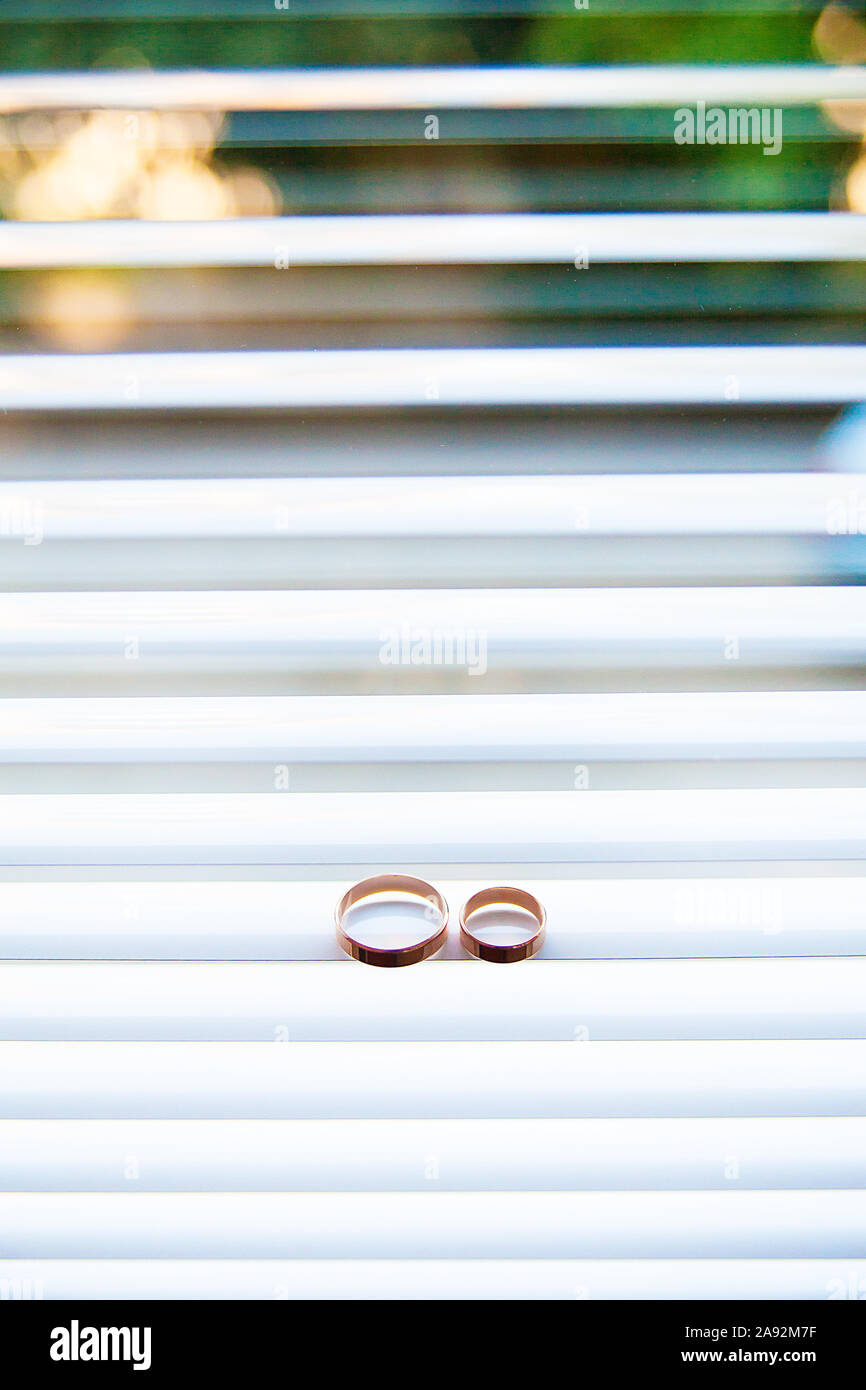 Two beautiful wedding rings on the window blinds Stock Photo - Alamy