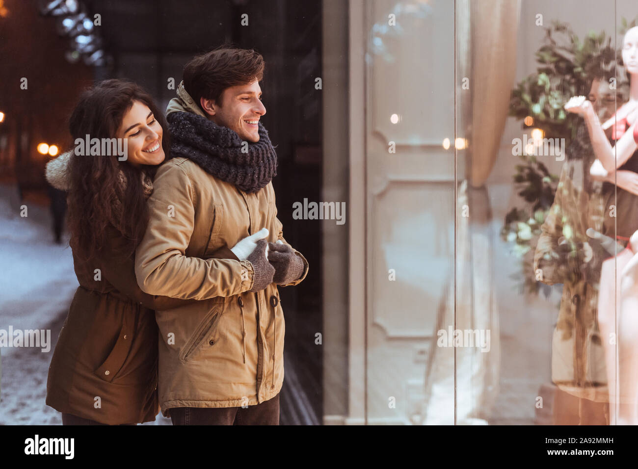Spouses Hugging Looking At Shopwindow Walking Outside At Night Stock ...