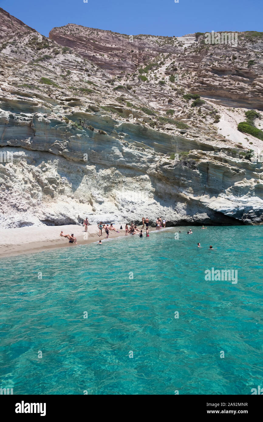 Tourists swimming in the clear, turquoise water of Galazia Nera Bay ...
