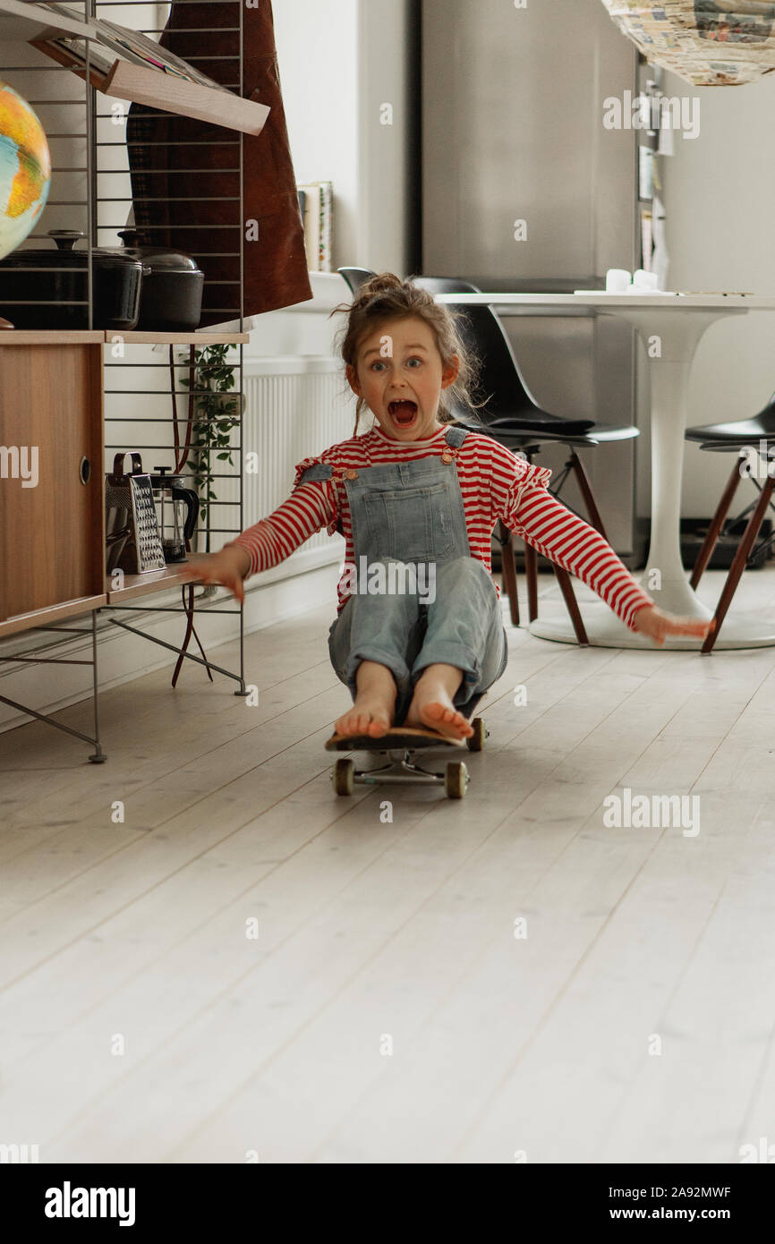 Girl on skateboard at home Stock Photo - Alamy