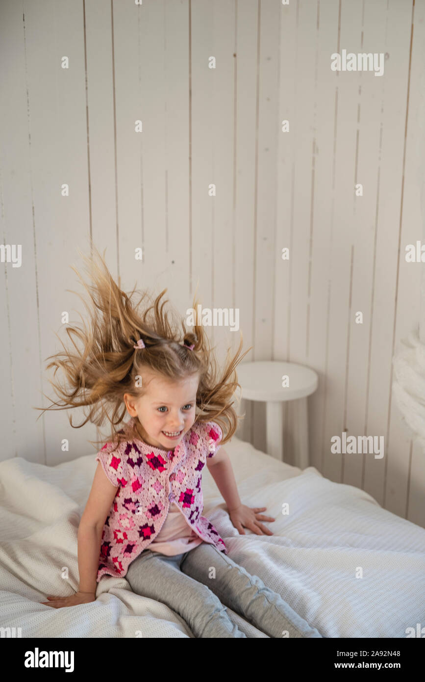 Girl jumping on bed Stock Photo - Alamy