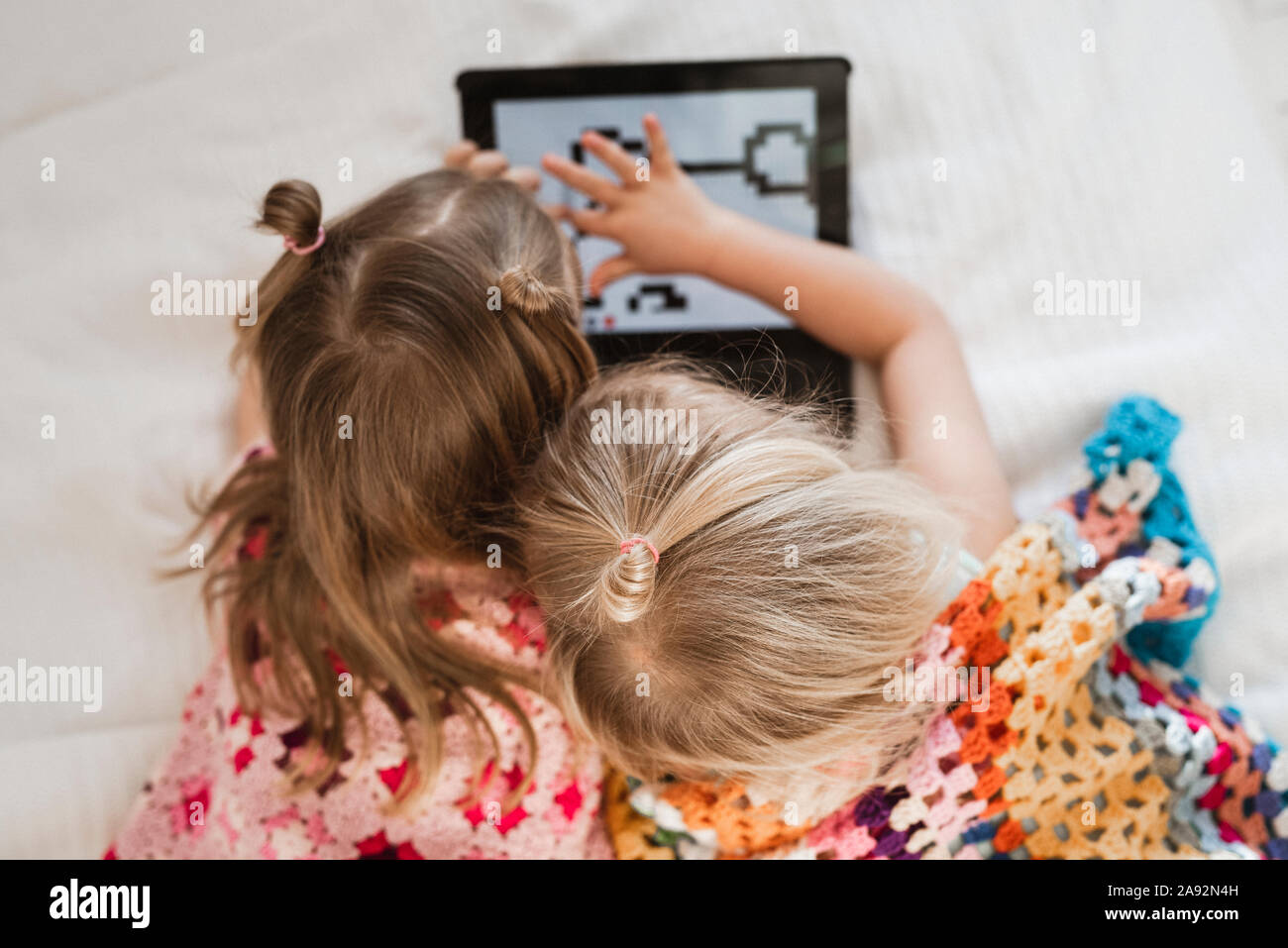 Girls using digital tablet Stock Photo - Alamy