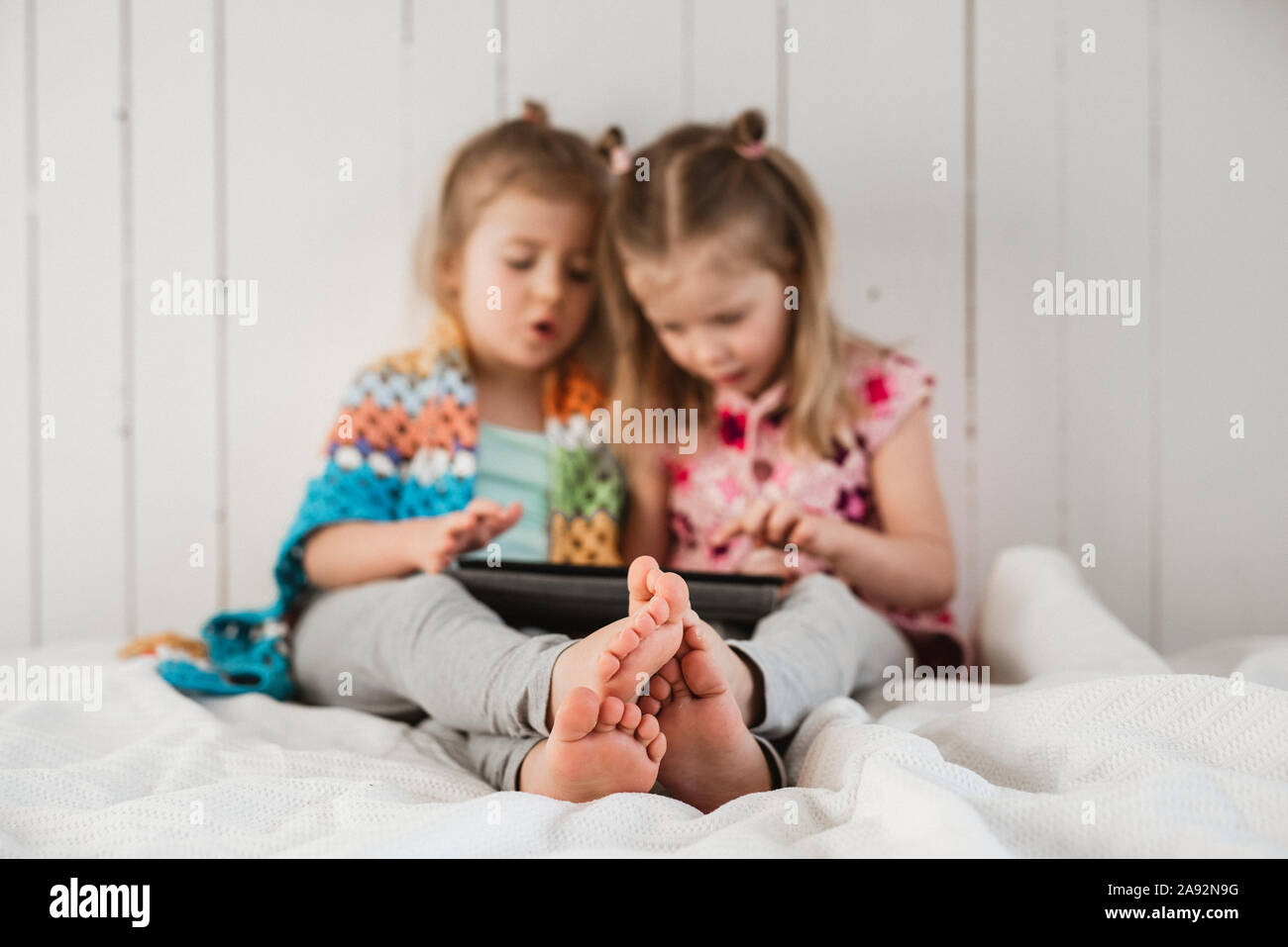 Girls using digital tablet Stock Photo - Alamy