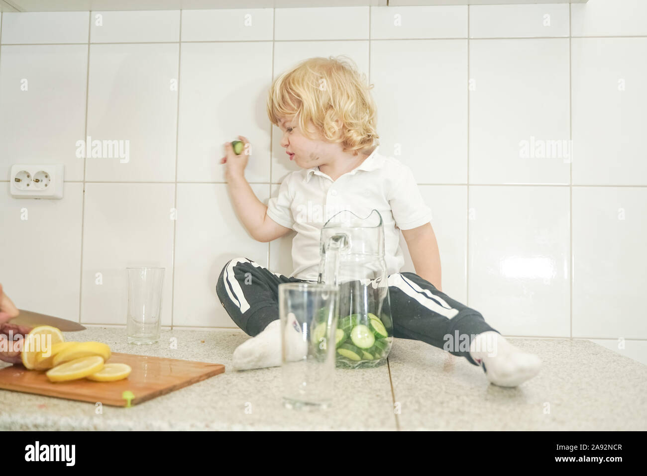 Portrait of an adorable mother and little baby child preparing a ...