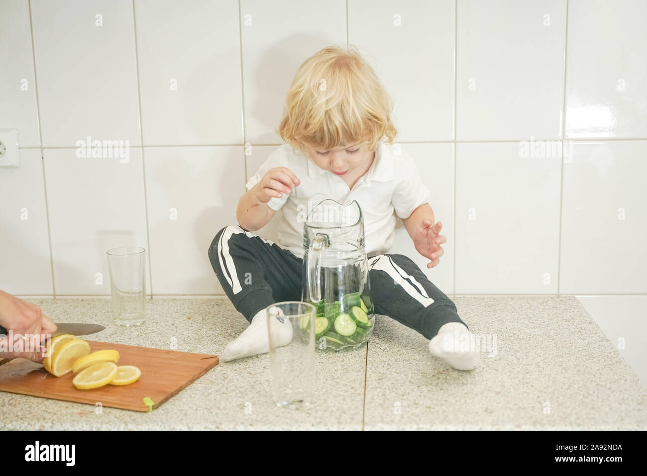 Portrait of an adorable mother and little baby child preparing a ...