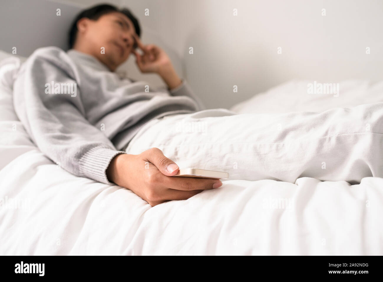 Man lying on bed Stock Photo - Alamy