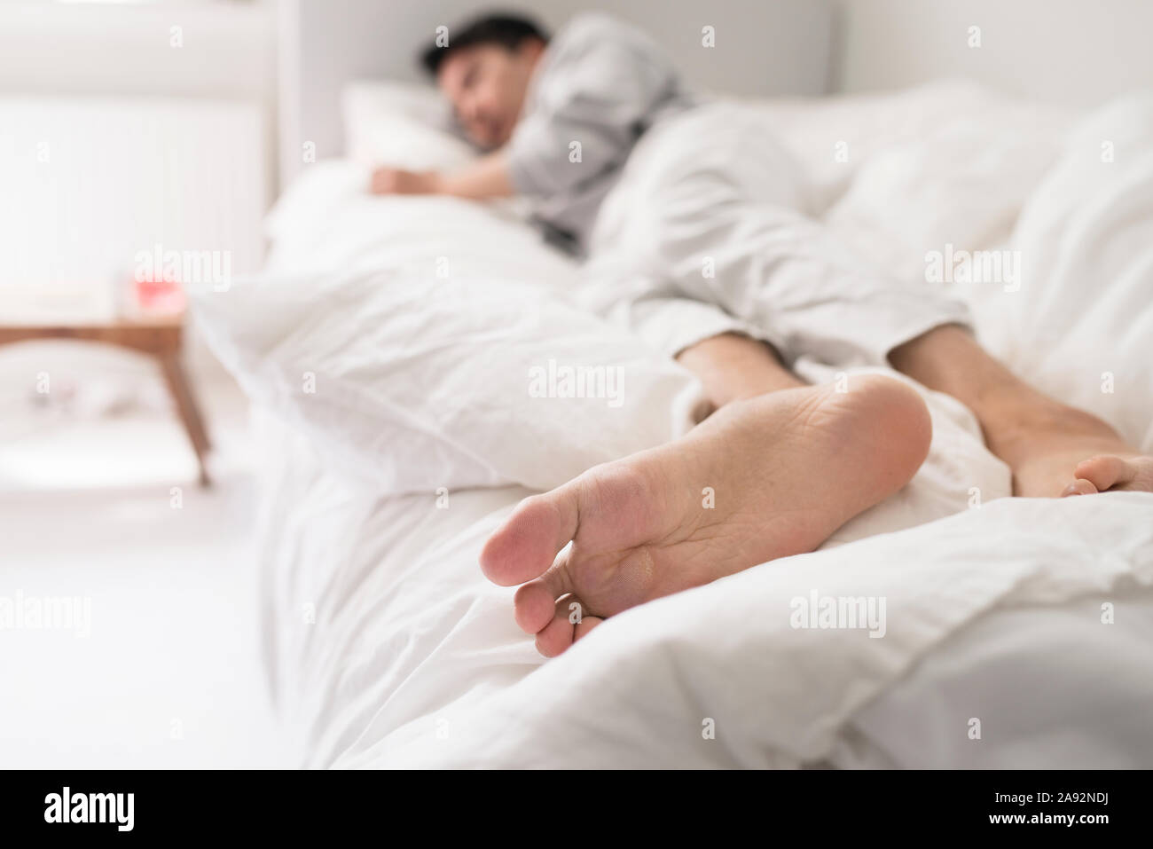 Person relaxing bed home barefoot hi-res stock photography and images ...