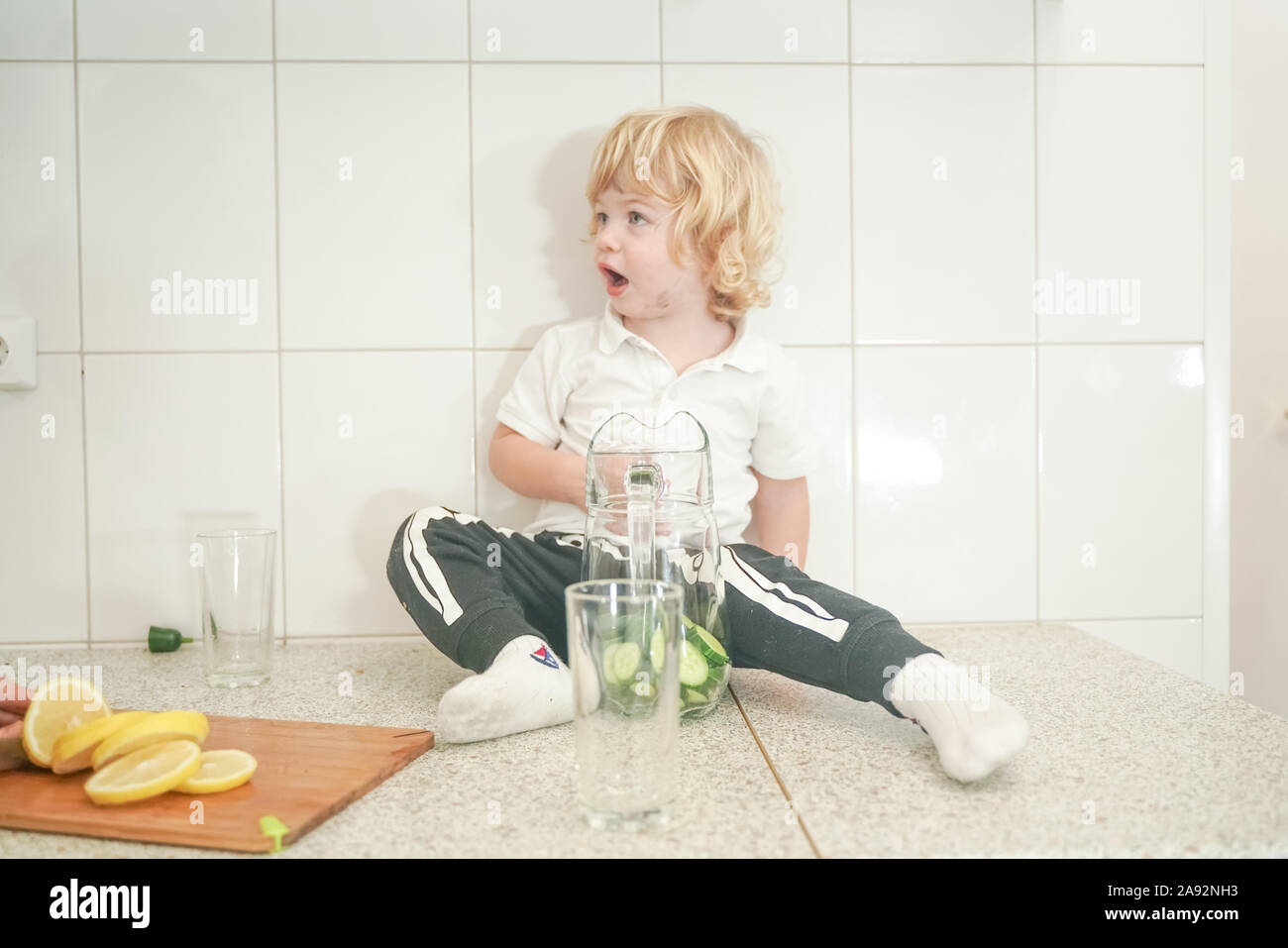 Portrait of an adorable mother and little baby child preparing a ...