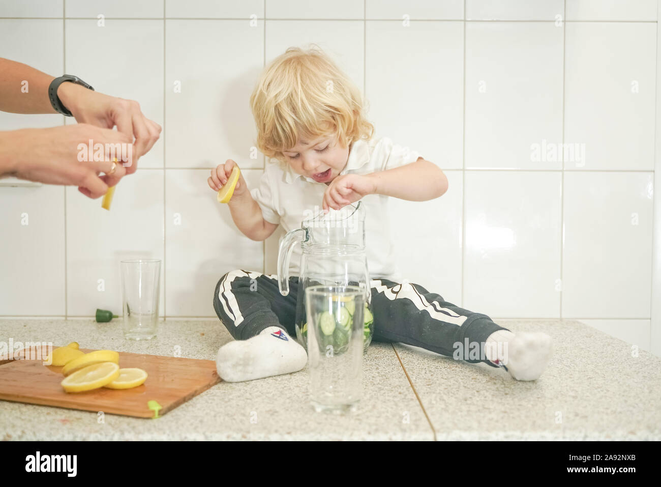 Portrait of an adorable mother and little baby child preparing a ...