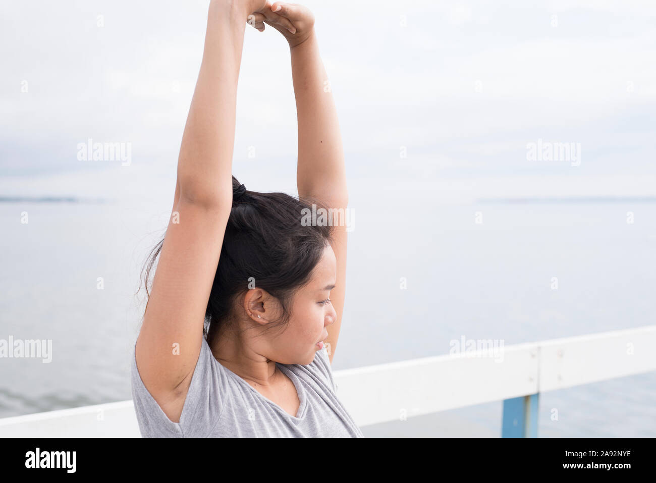 Woman stretching arms over head hi-res stock photography and images - Alamy