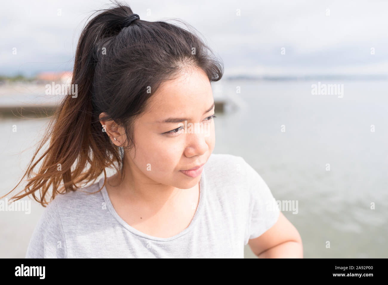 Young woman looking away Stock Photo - Alamy