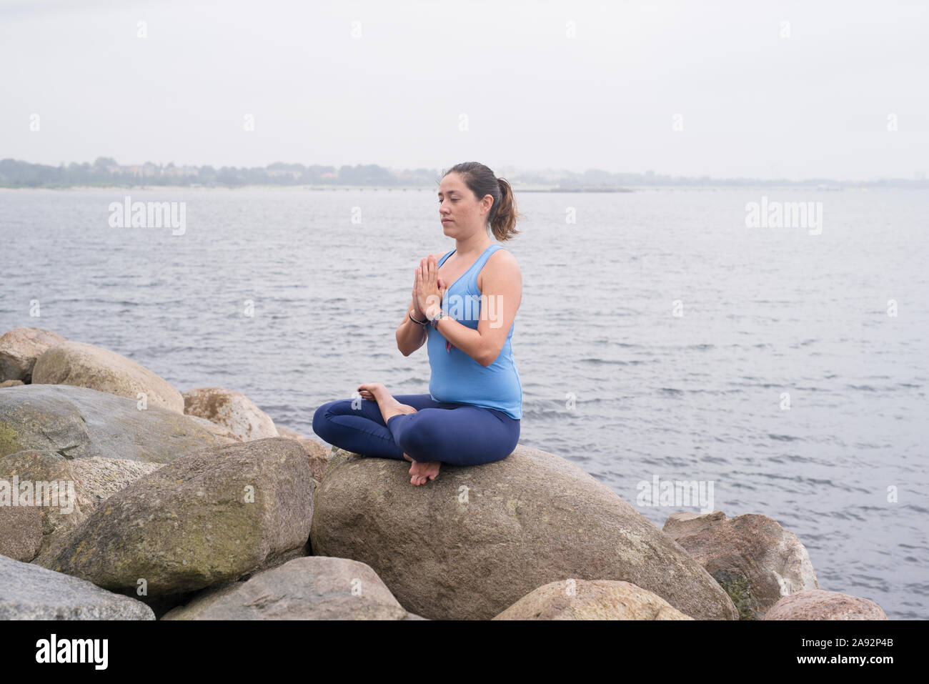 Woman meditating at sea Stock Photo - Alamy