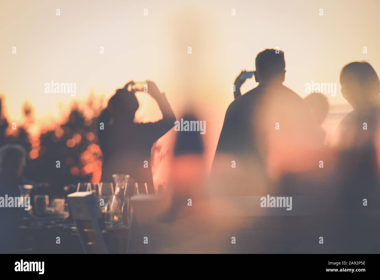 Group of people looking into orange sky watching something Stock Photo ...
