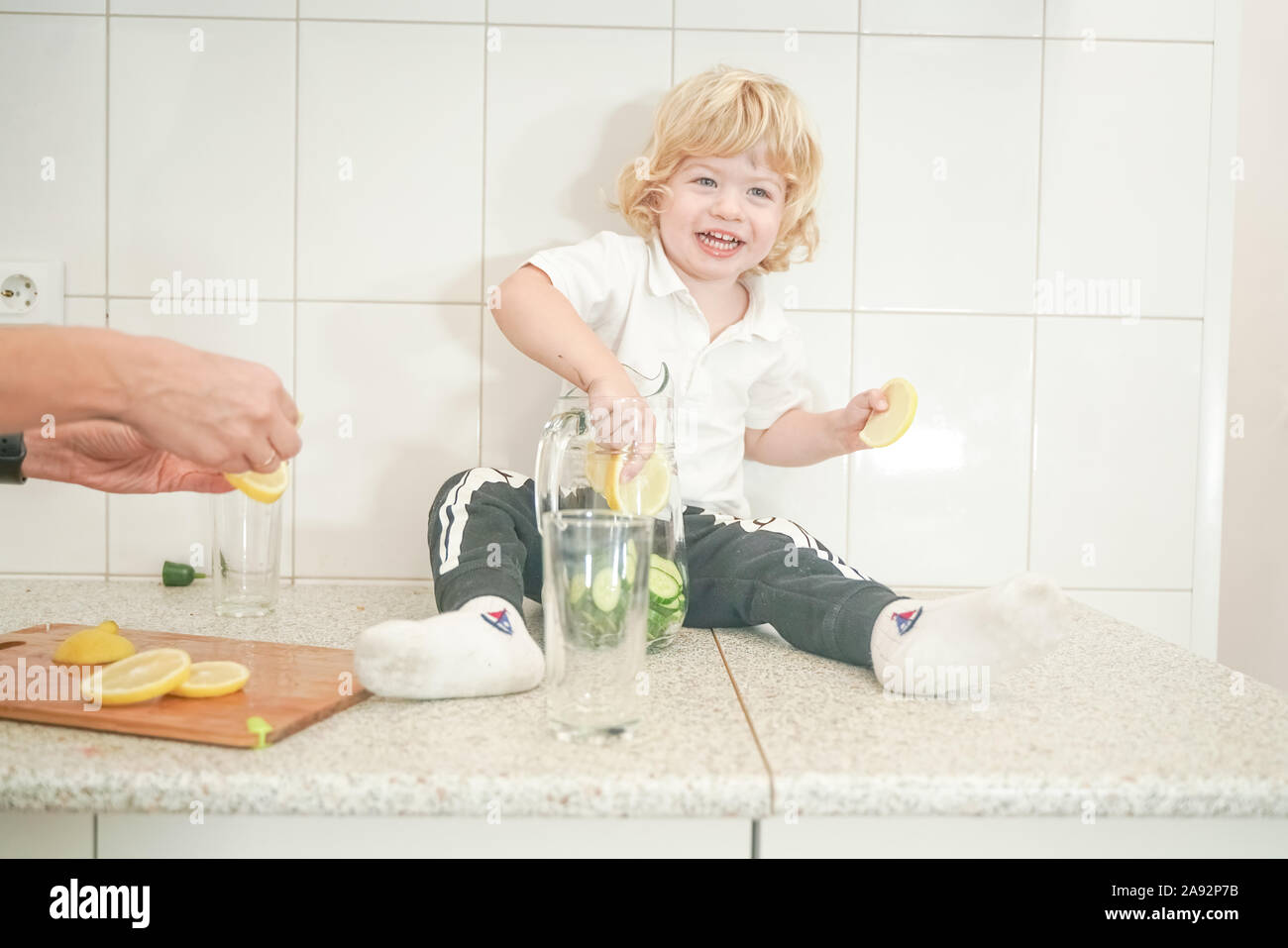 Portrait of an adorable mother and little baby child preparing a ...