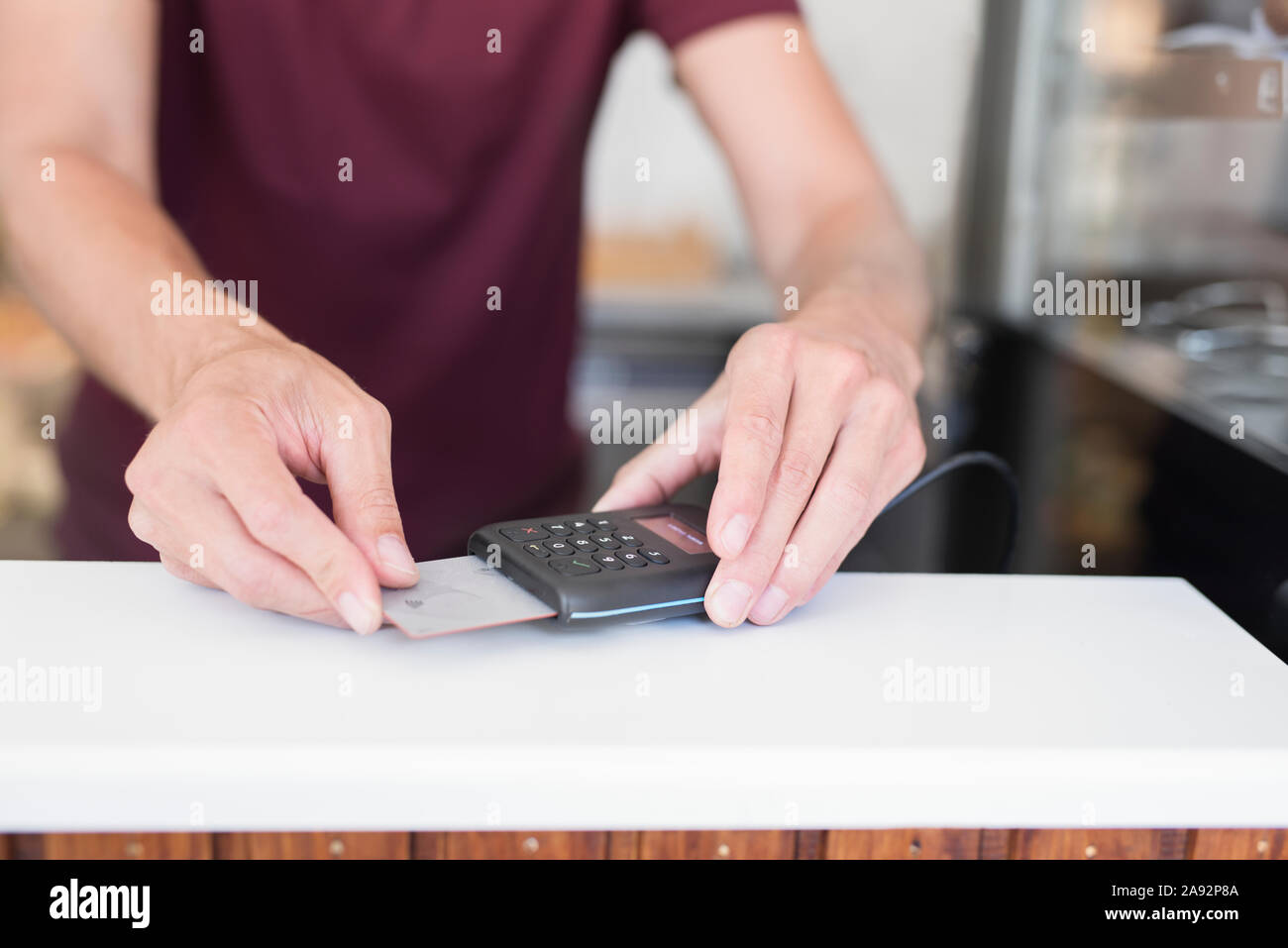 Putting credit card into card reader Stock Photo - Alamy