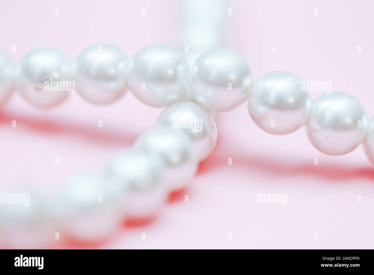 string of pearls delicate pink color, in soft focus, with highlights ...