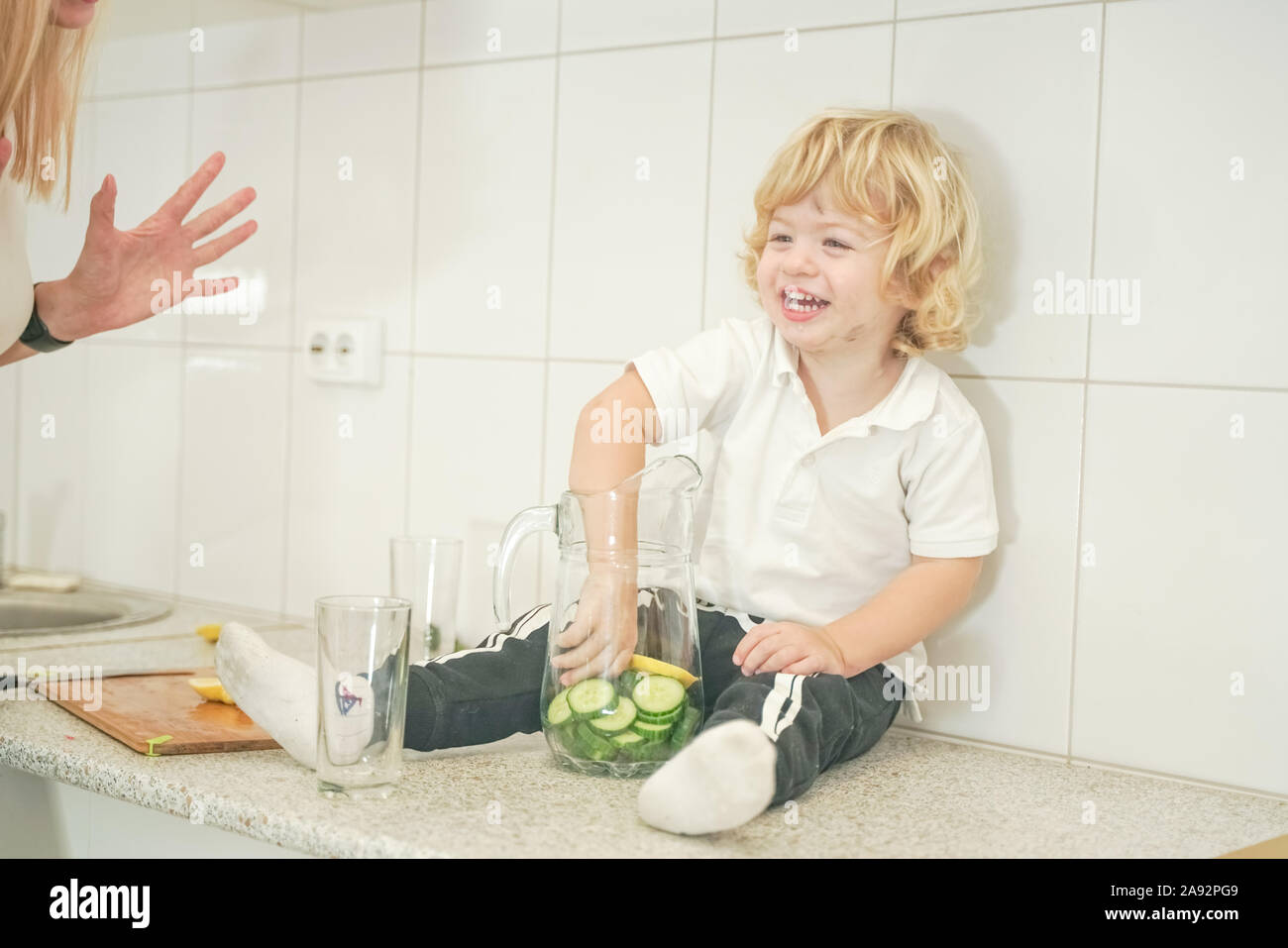Portrait of an adorable mother and little baby child preparing a ...