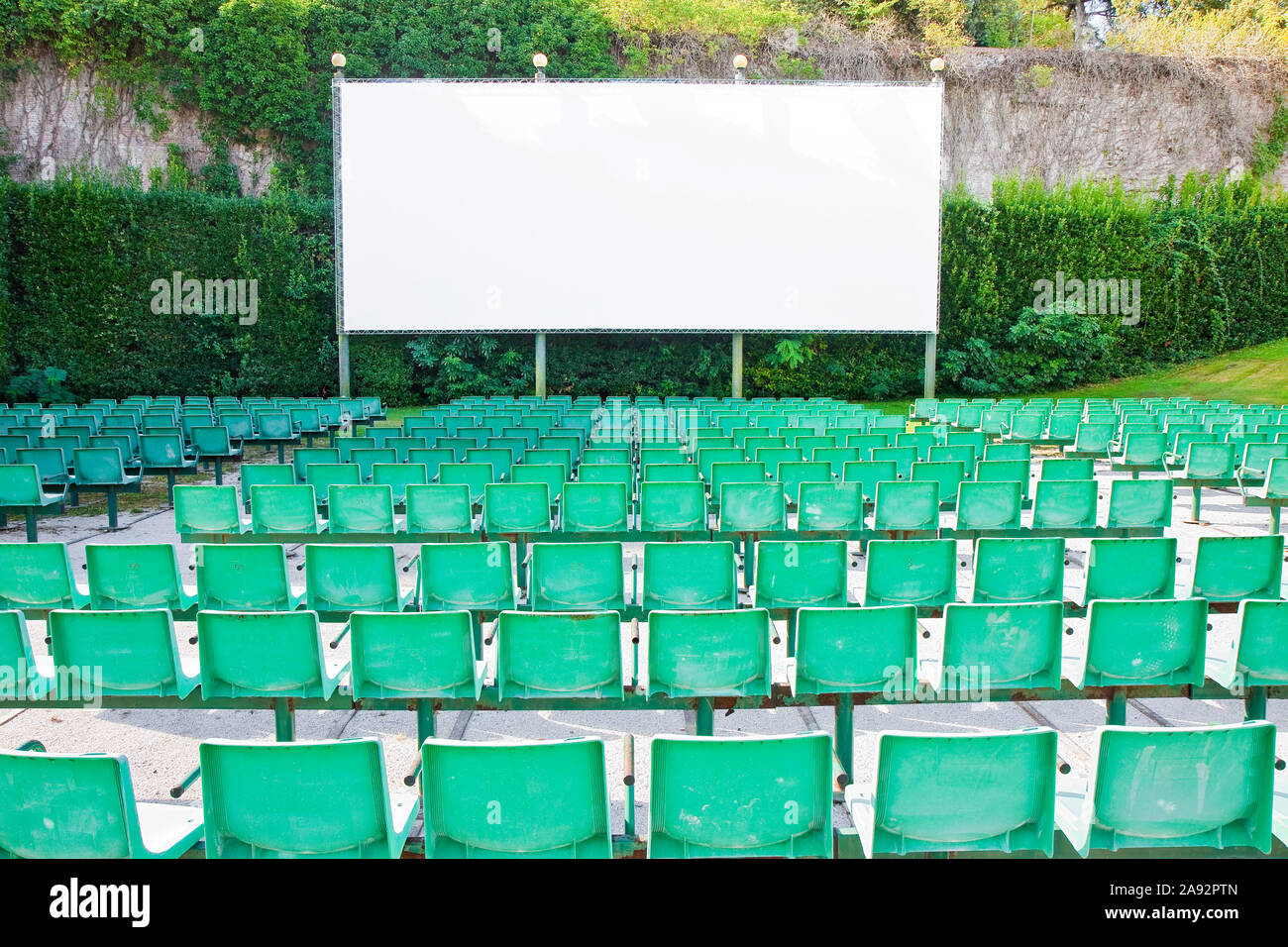 Outdoor cinema with chairs and white projection screen Stock Photo - Alamy