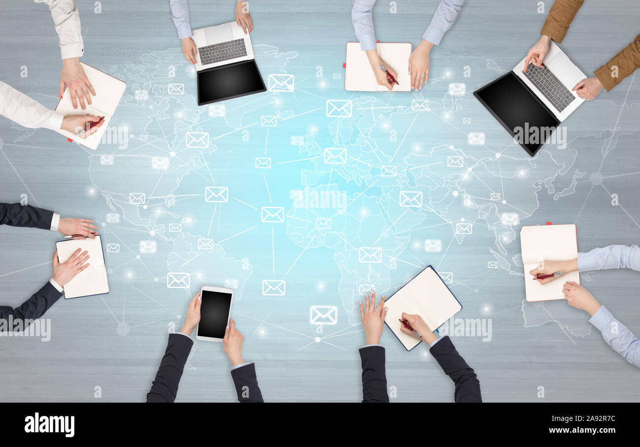 Group of people with devices in hands working in team on tablets ...