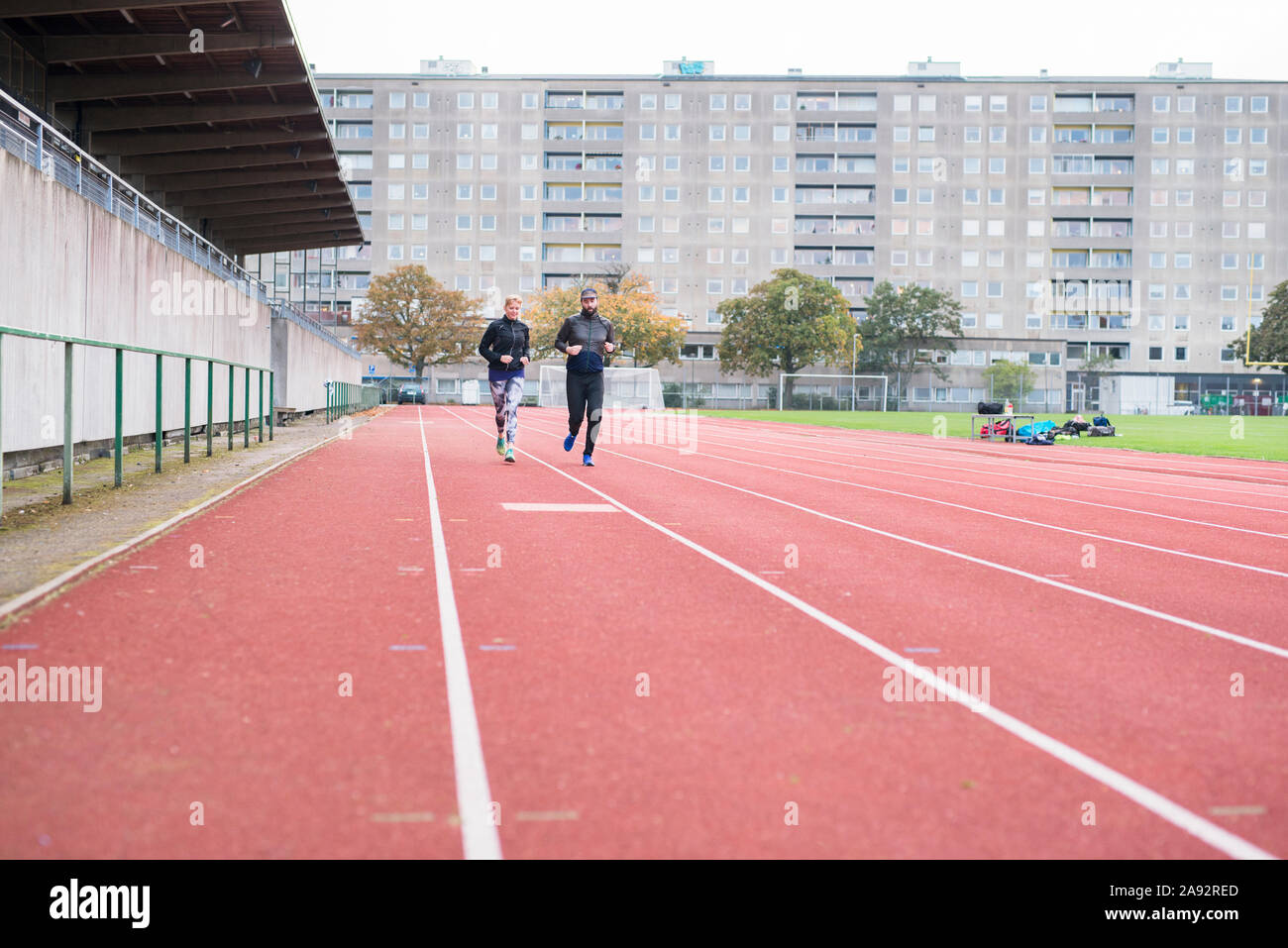 Man and woman on running track Stock Photo - Alamy