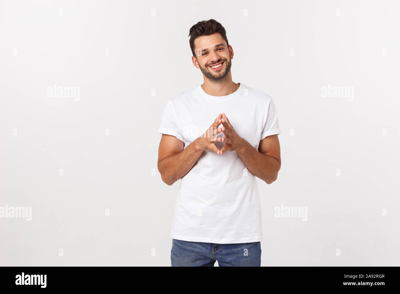 Portrait of a handsome young man smiling against yellow background ...