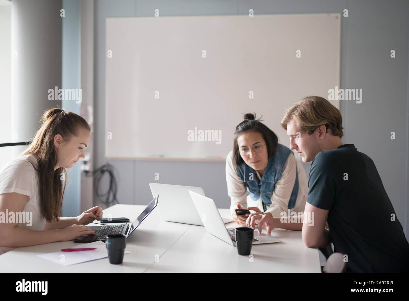 Three colleagues sitting business meeting hi-res stock photography and ...