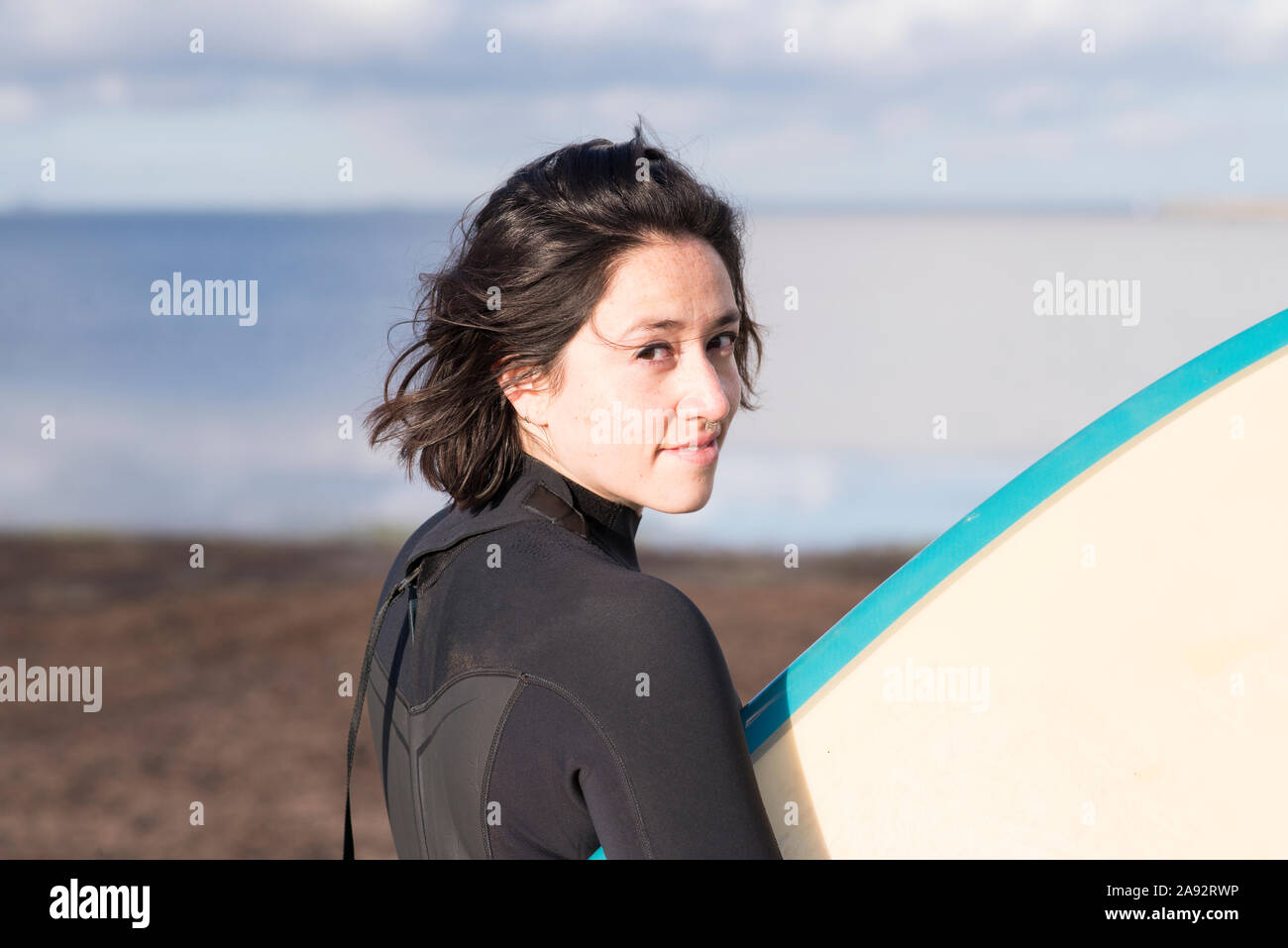 Female surfer with surfboard Stock Photo - Alamy